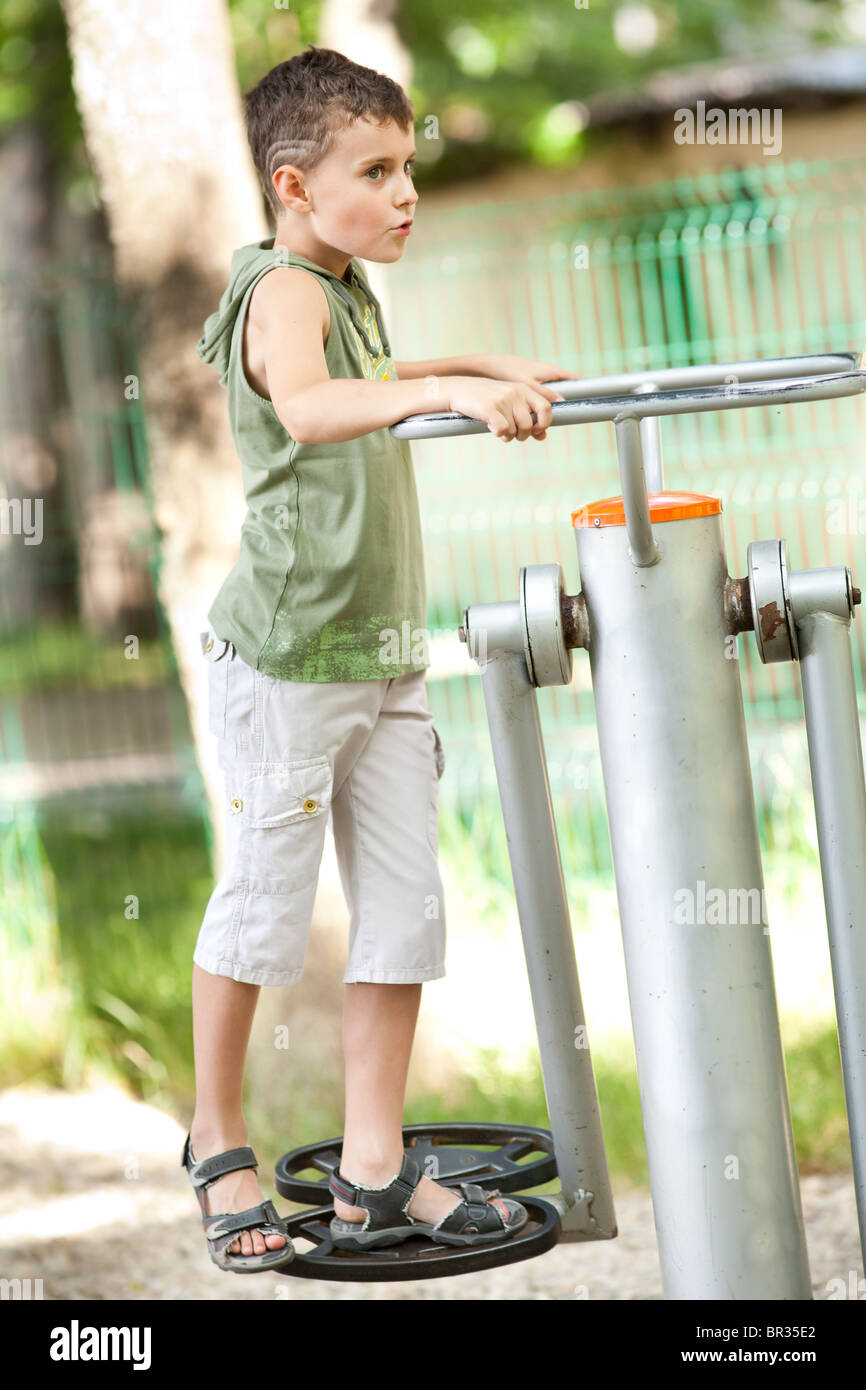 Kid with cool haircut doing fitness outdoor and having fun Stock Photo ...