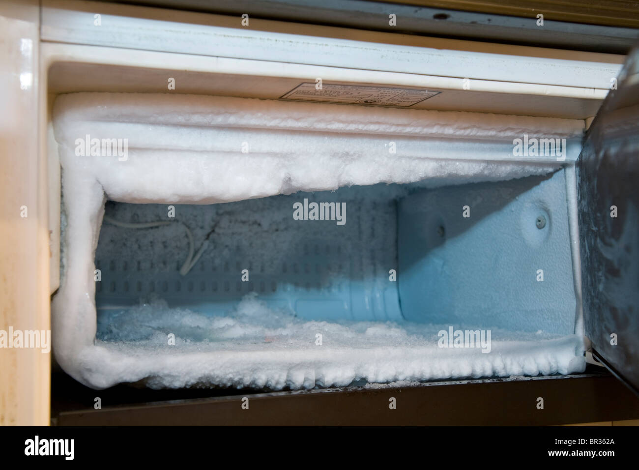 Frozen ice box iced up with thick ice Stock Photo - Alamy