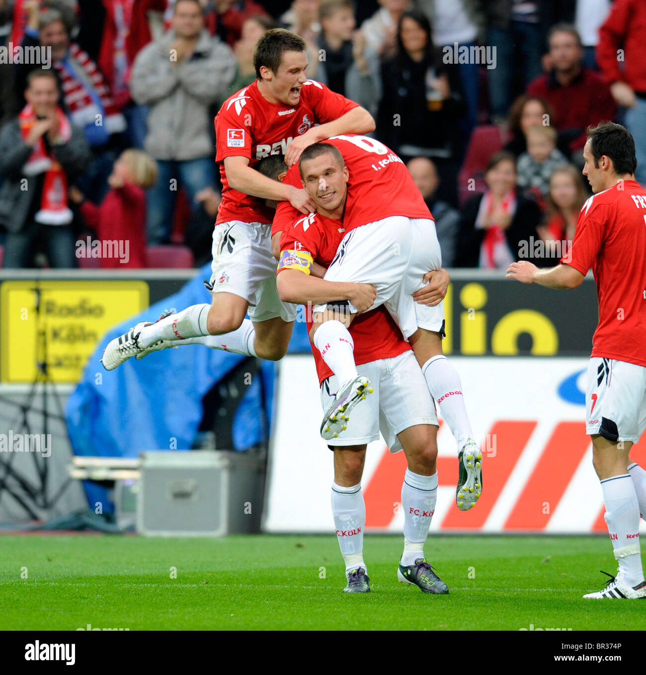 Cologne players Christian Clemens, Lukas Podolski and Taner Yalcin ...