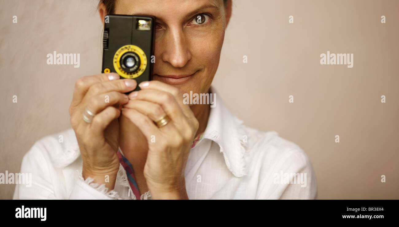 Woman with camera ,focus point on eye Stock Photo - Alamy