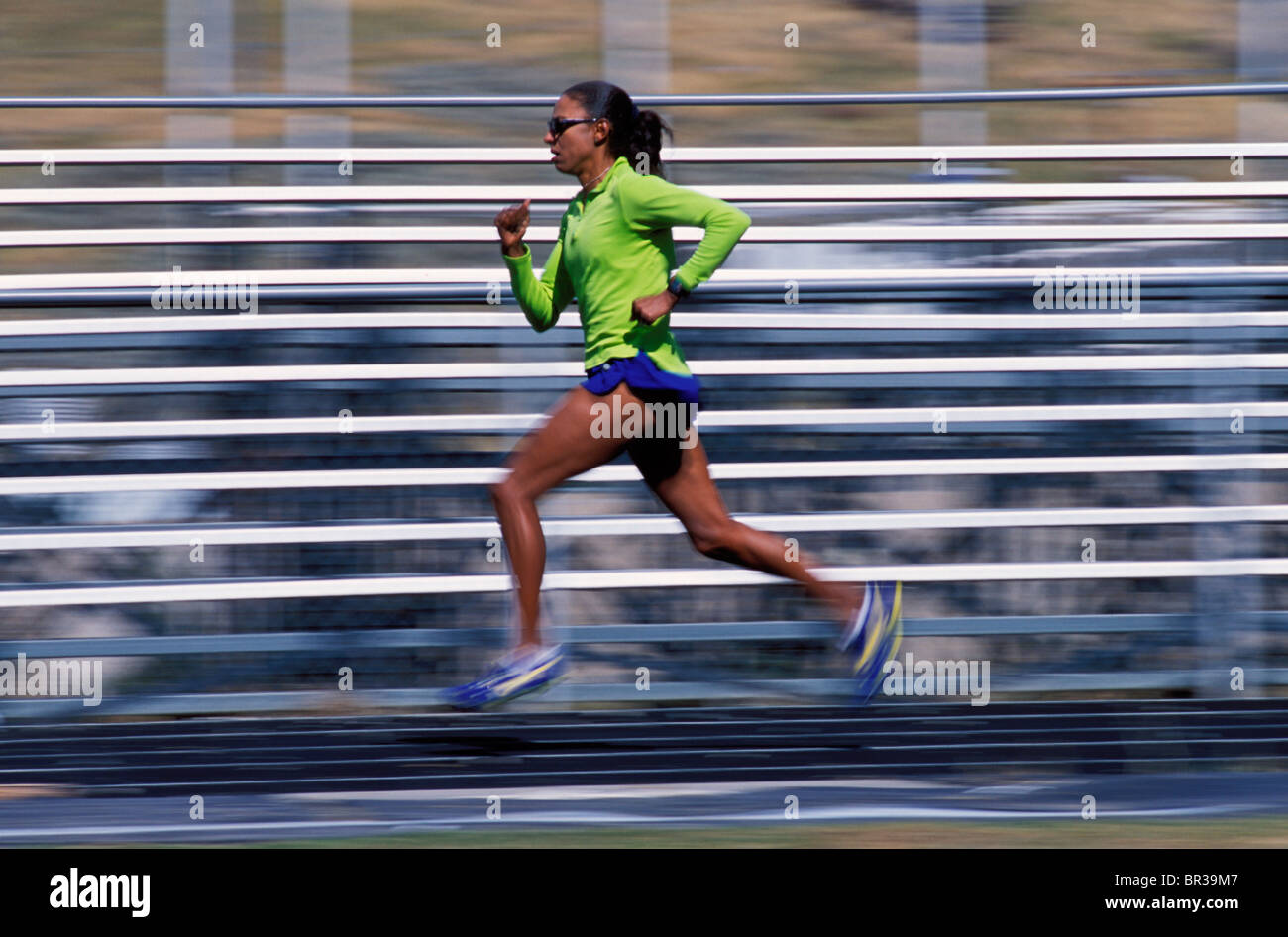 Attractive female running on a track Stock Photo - Alamy