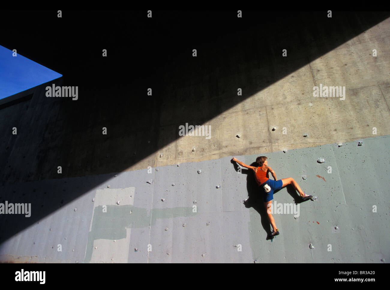 Woman buildering on a concrete wall Stock Photo - Alamy