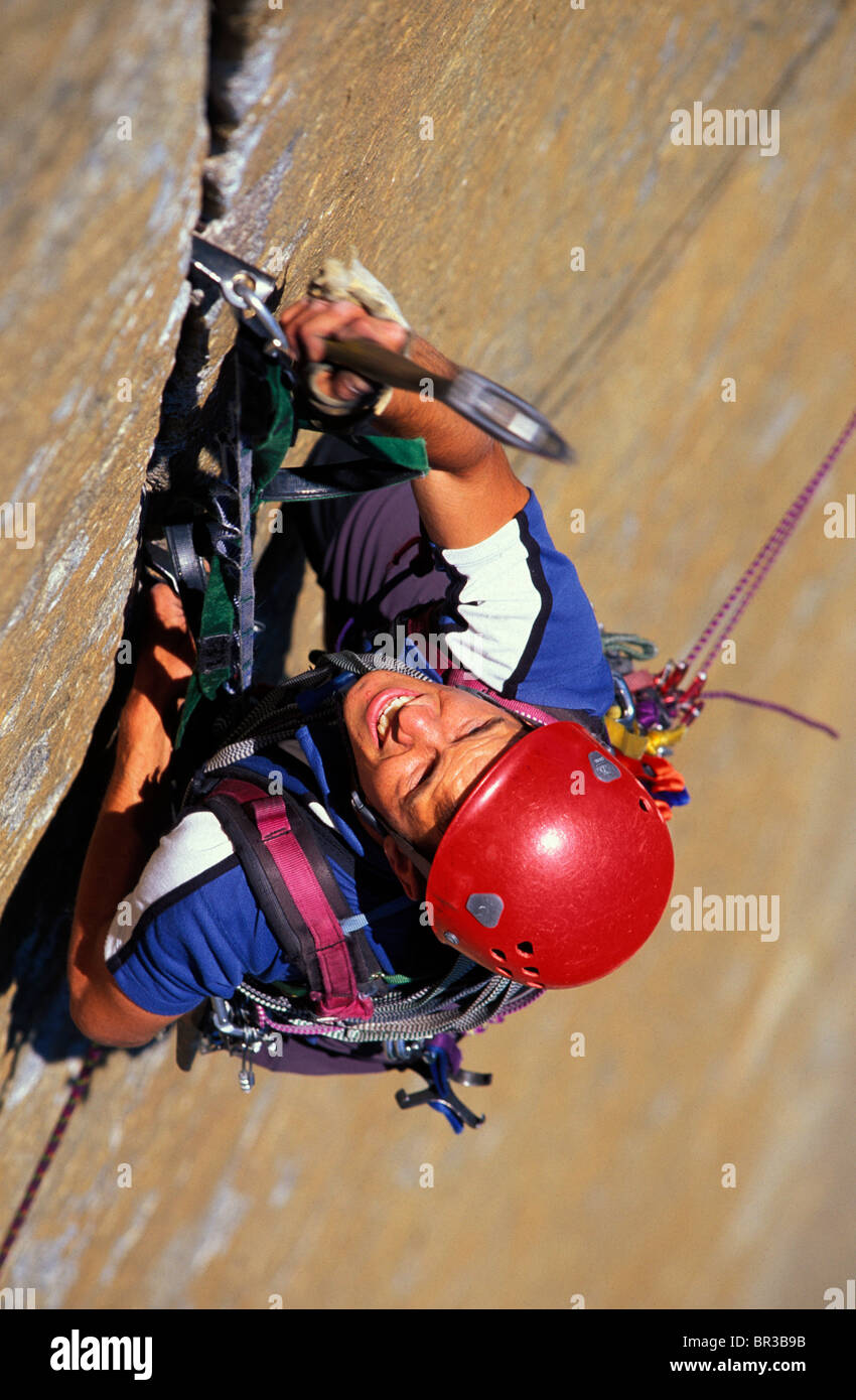 Man climbing a big wall and placing protection (high angle perspective ...