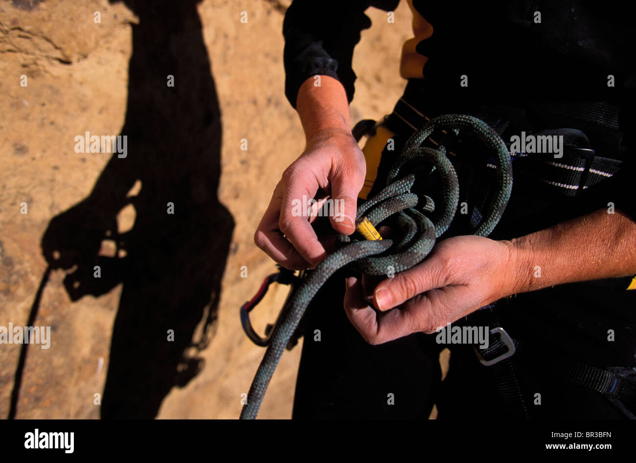 Hands tying a figure eight follow through onto a harness Stock Photo ...