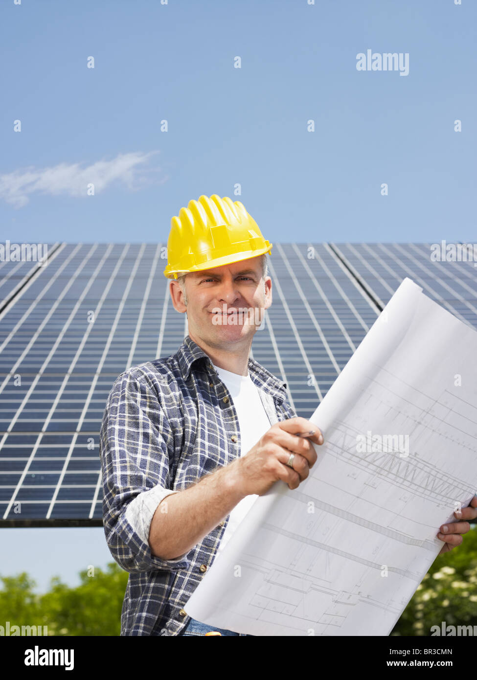 engineer holding blueprints in solar power station Stock Photo - Alamy