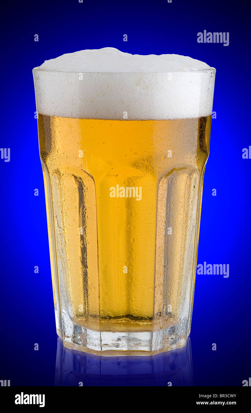 glass of beer on a blue background Stock Photo - Alamy