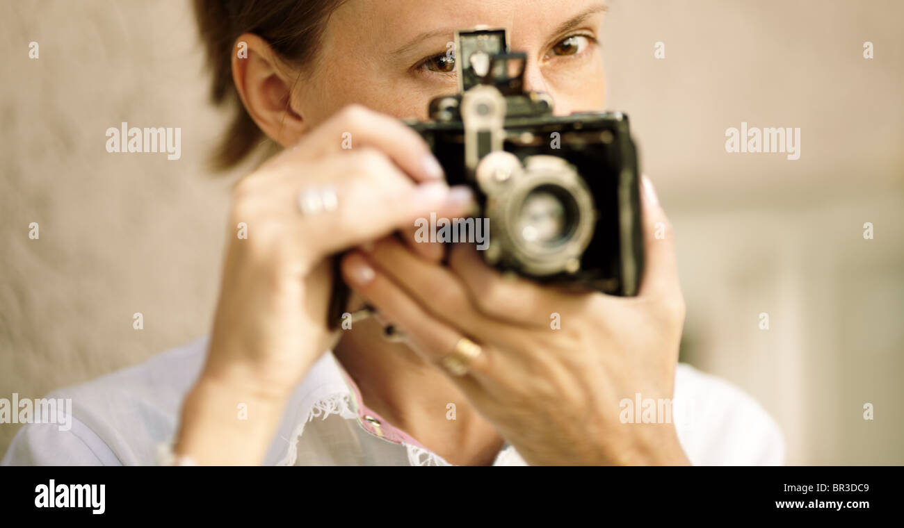 Woman with camera ,focus point on eye Stock Photo - Alamy