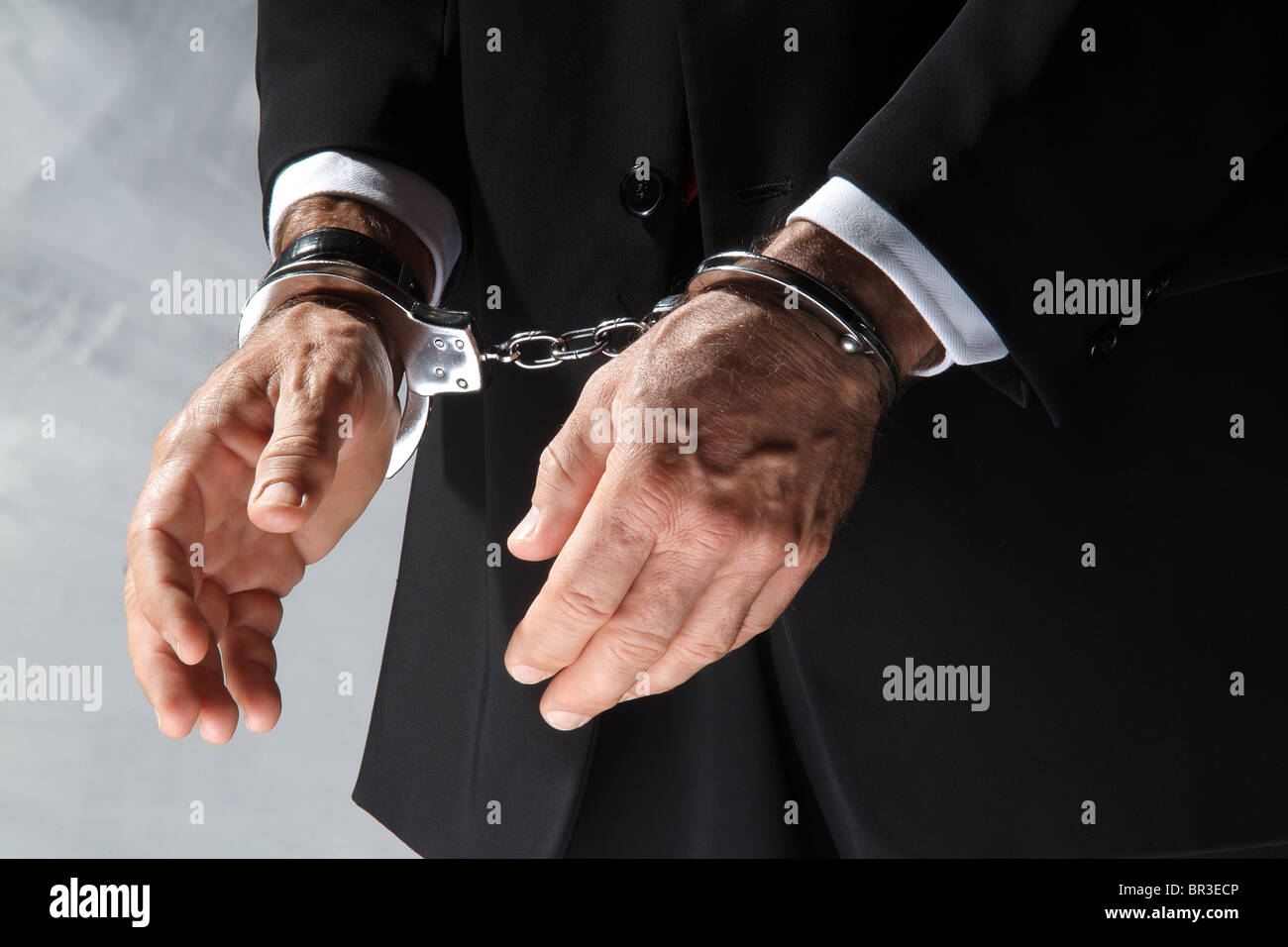 Man handcuffed suit hi-res stock photography and images - Alamy