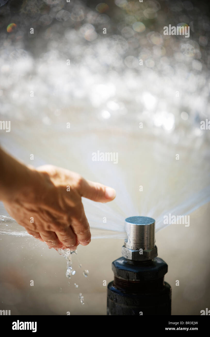 A hand in a playground sprinkler Stock Photo - Alamy