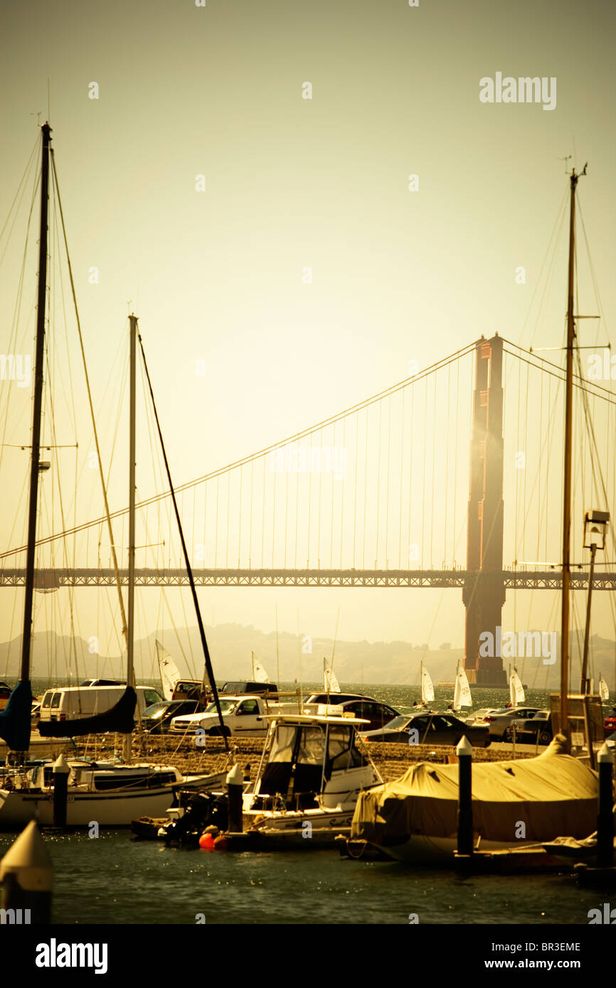 The Marina, boats and masts with the Golden Gate Bridge in the ...