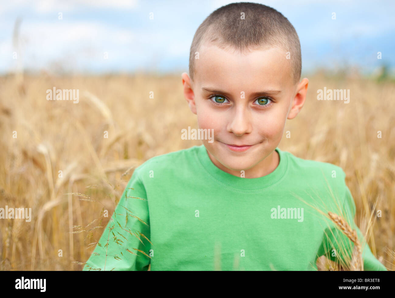 Portrait of a cute and happy kid in a wheat field Stock Photo - Alamy