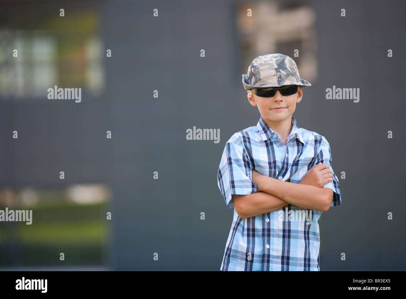 Cute kid with sunglasses and hat in an urban environment Stock Photo ...