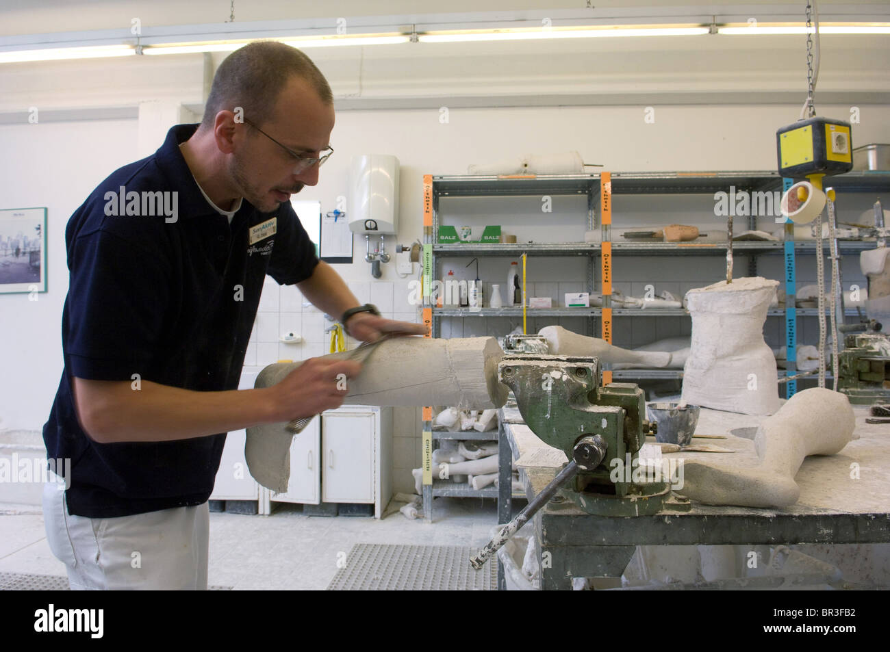 An orthopaedic technician making a plaster form, Berlin, Germany Stock ...