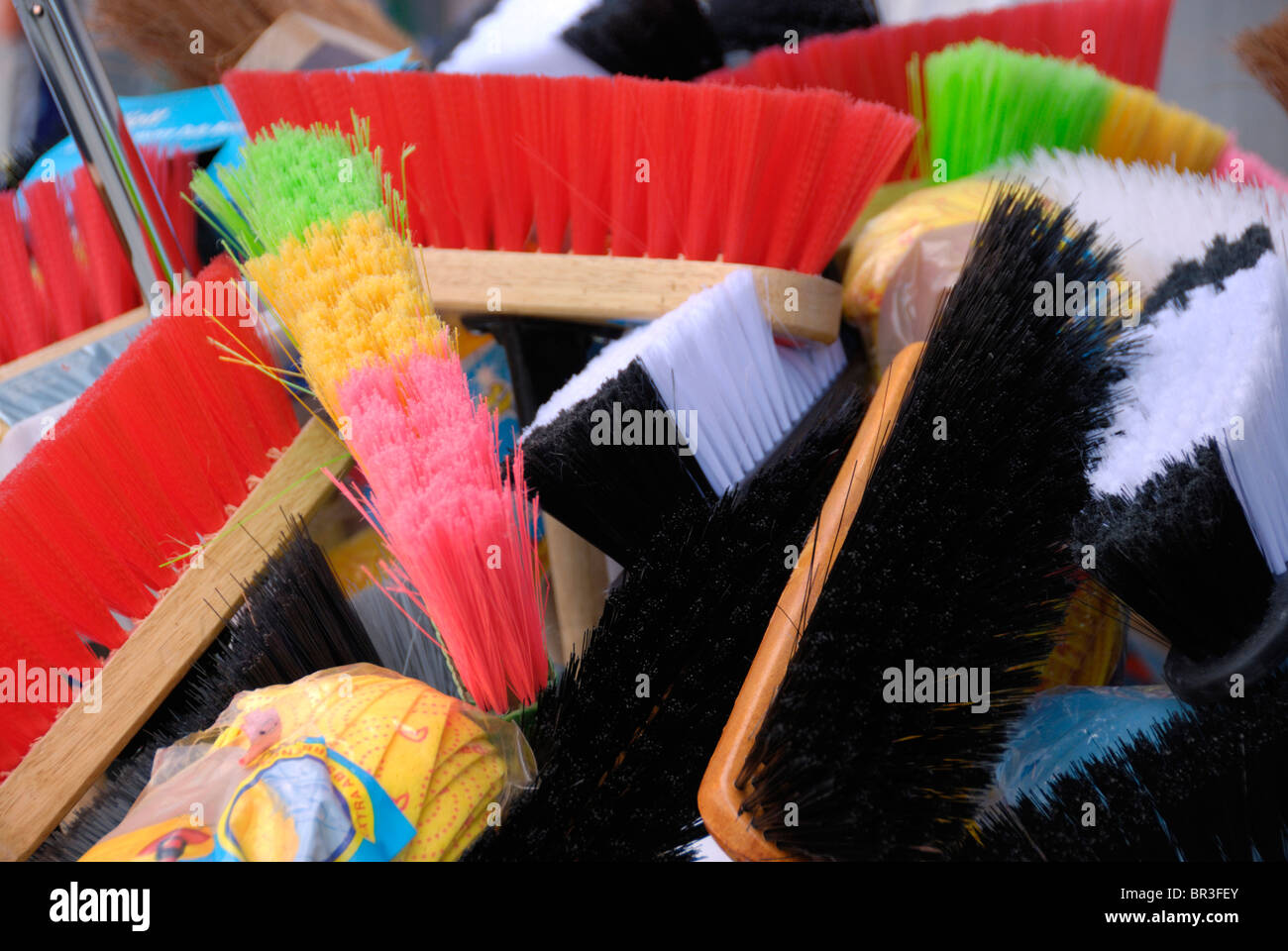 Colorful brooms on display outside a hardware store Stock Photo - Alamy