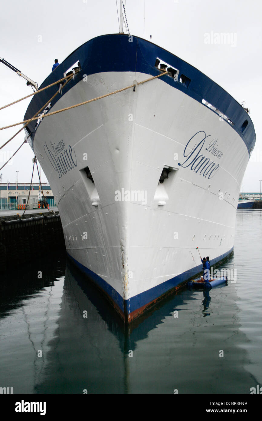Cleaning a big industrial ship by hand Stock Photo - Alamy
