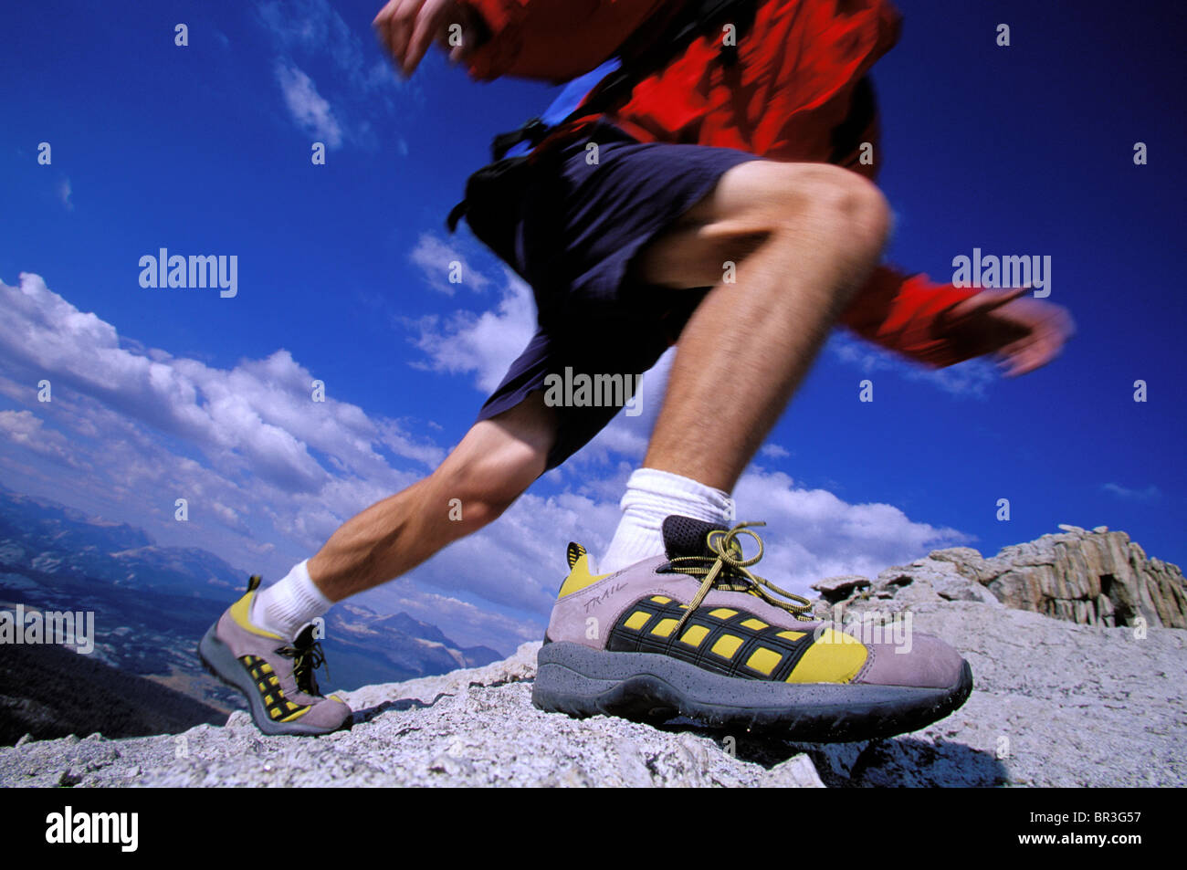 Low angle perspective of a man hiking high above tree line Stock Photo ...