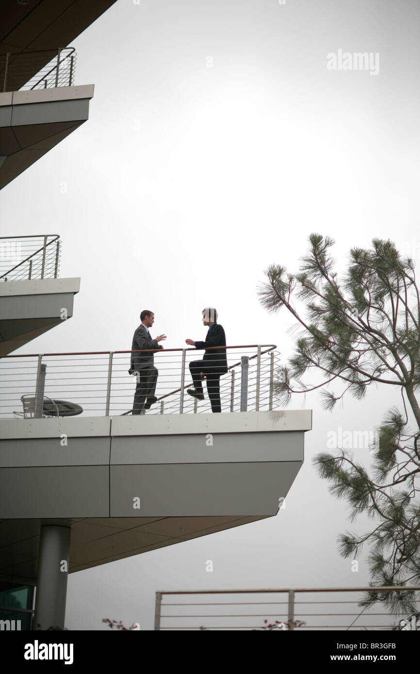 Two businessmen chat outside Stock Photo - Alamy