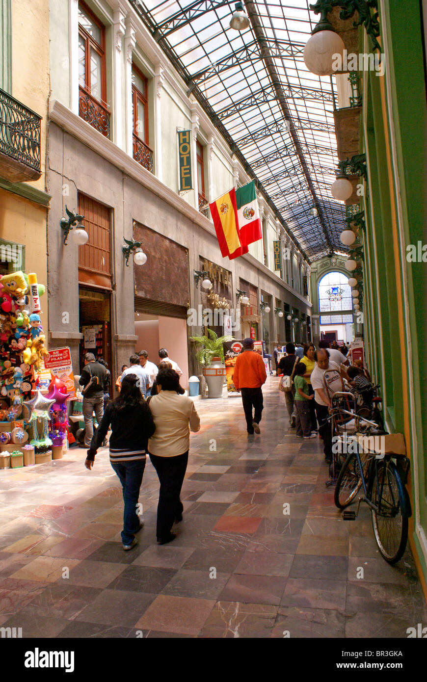 People in a covered pedestrian walkway and shopping mall, Puebla ...