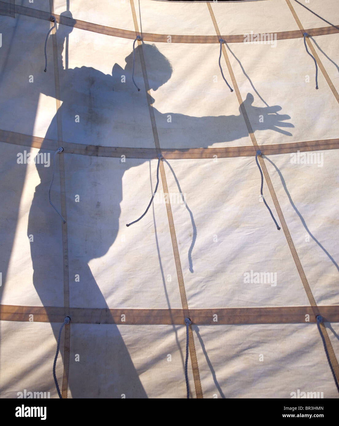 Shadow of a sailor behind sail Stock Photo - Alamy