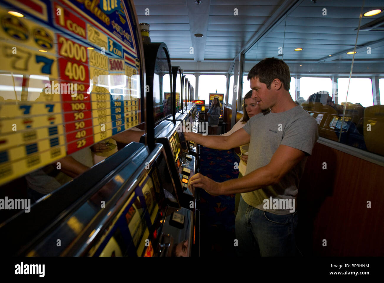 Passengers play Slot machines aboard the high speed Cat ferry Stock ...