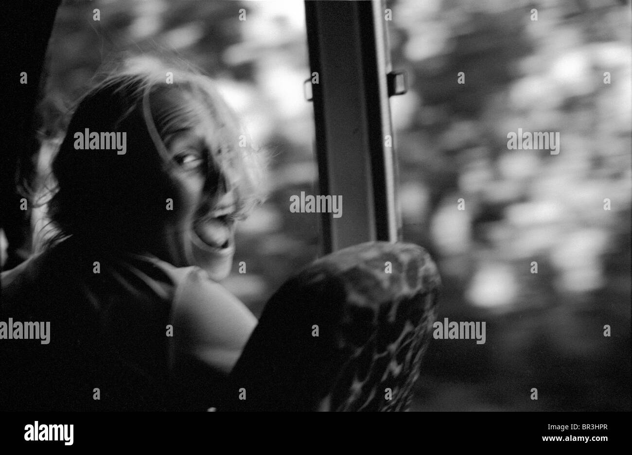 Young woman laughing beside open window on a tourist bus in El Salvador ...