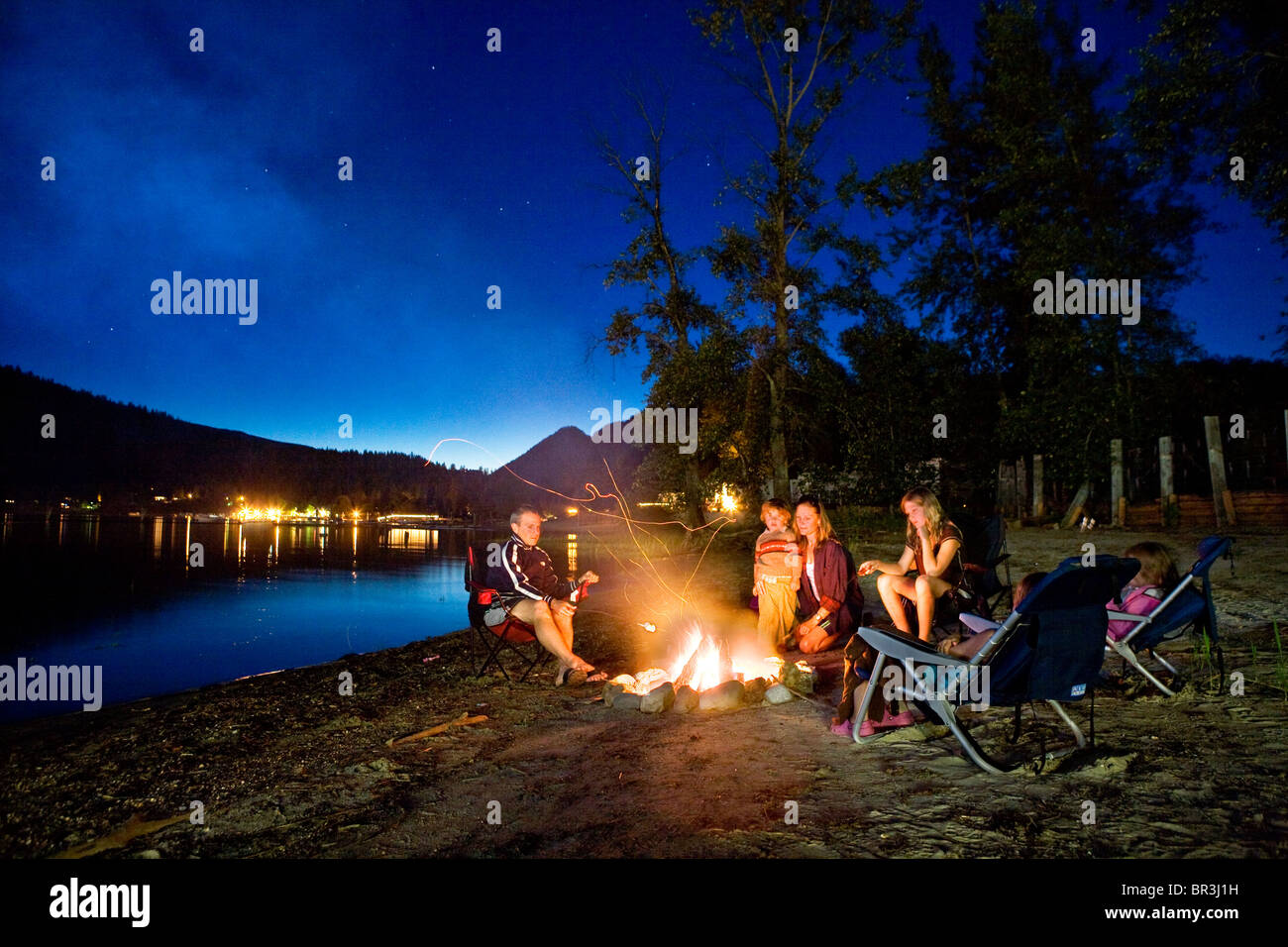 Family bonfire on shores of Mara Lake, BC Stock Photo - Alamy