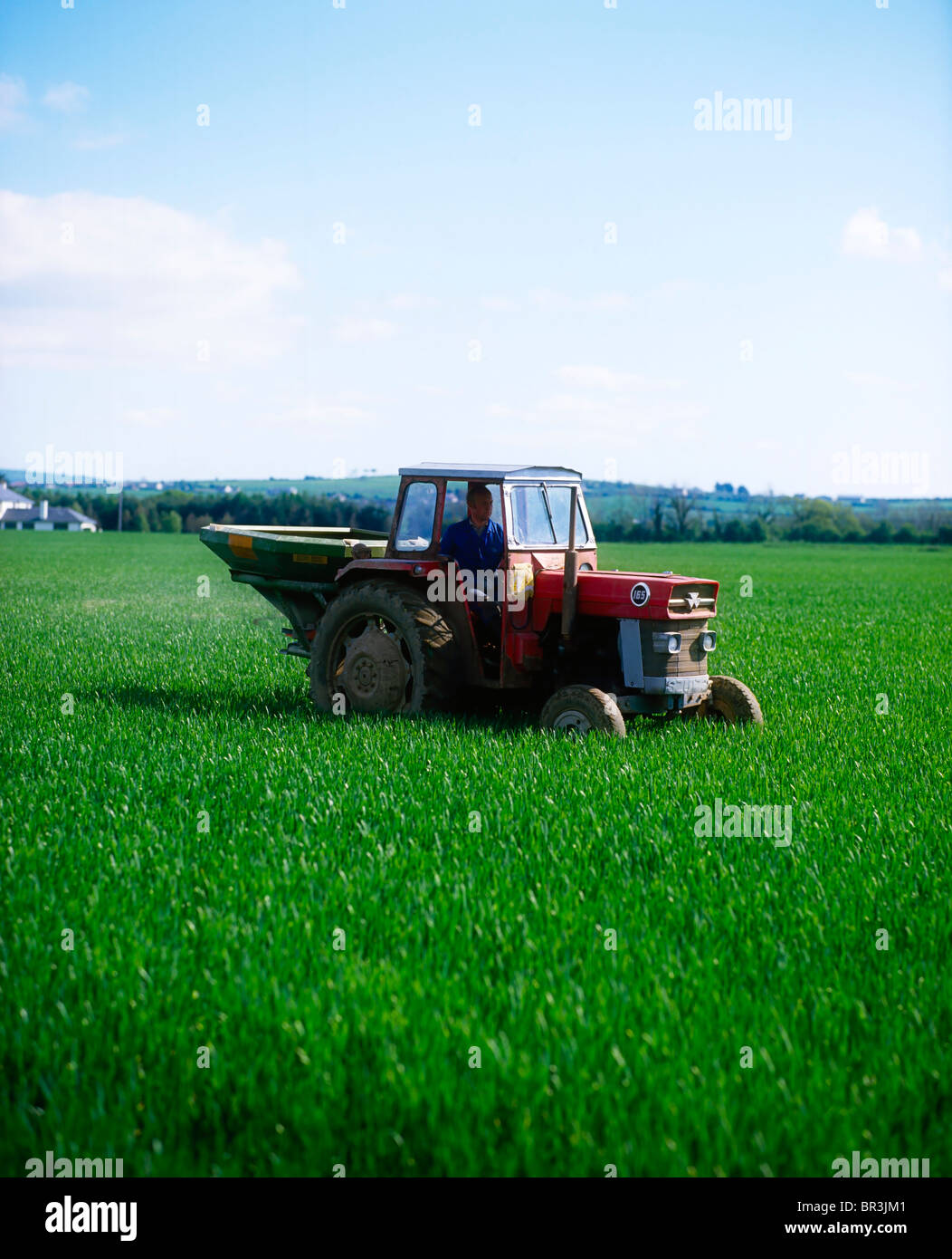 Man Driving Tractor,Fertilizing His Crop Stock Photo - Alamy