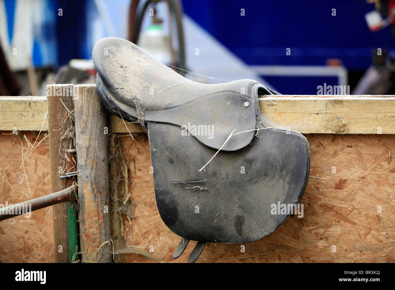 An old dusty saddle in a stable Stock Photo - Alamy