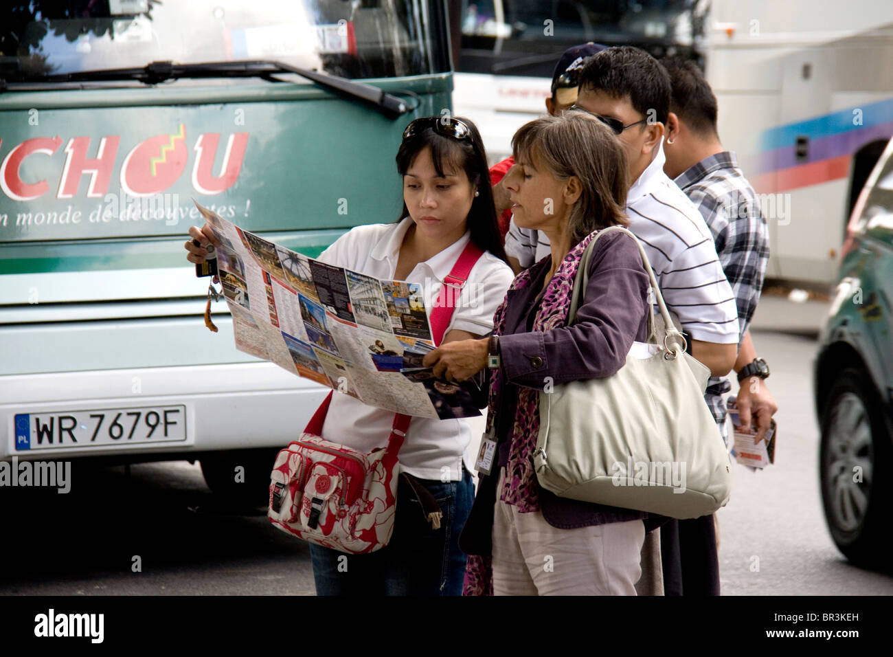 tourists showing map to tourist guides to find the local places Stock ...
