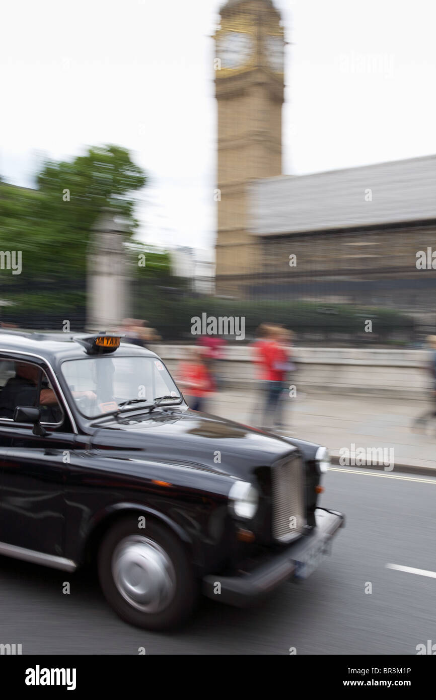 London taxi passing Big Ben and the Houses of Parliament Stock Photo ...