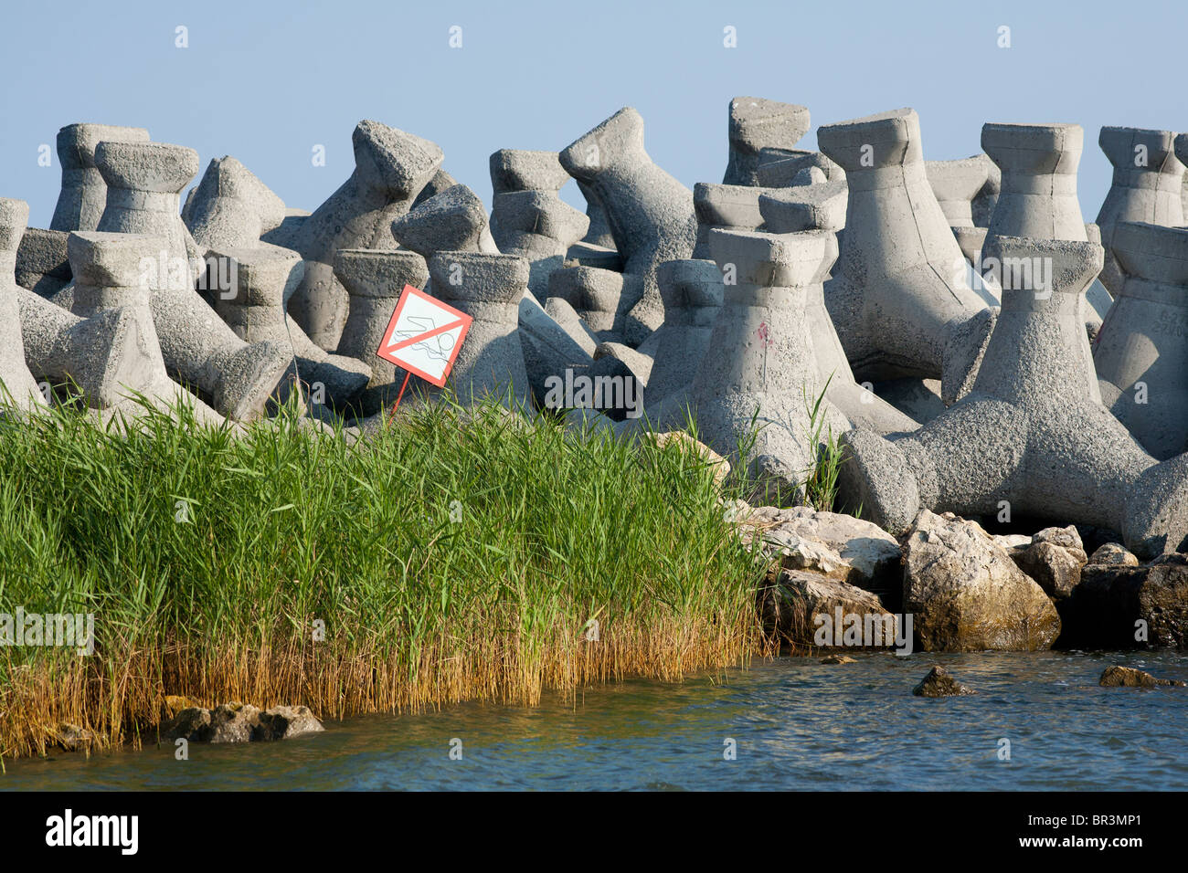 Landscape with breakwater dam rocks and blue sky Stock Photo - Alamy