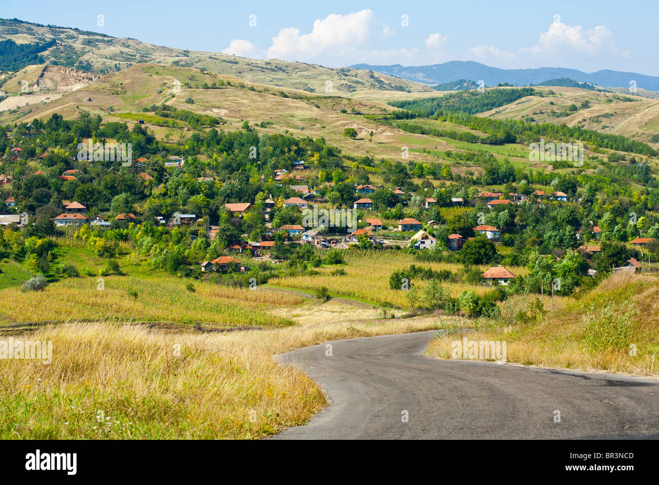 Alpine landscape with a road going to a village Stock Photo - Alamy