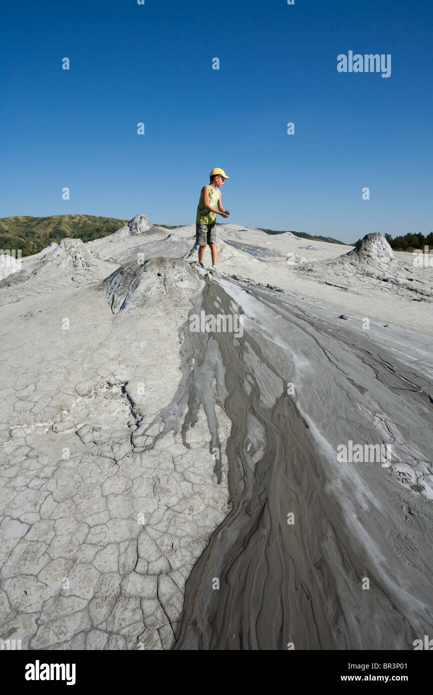 Cute kid playing with mud from muddy volcanoes at Berca, Romania Stock ...