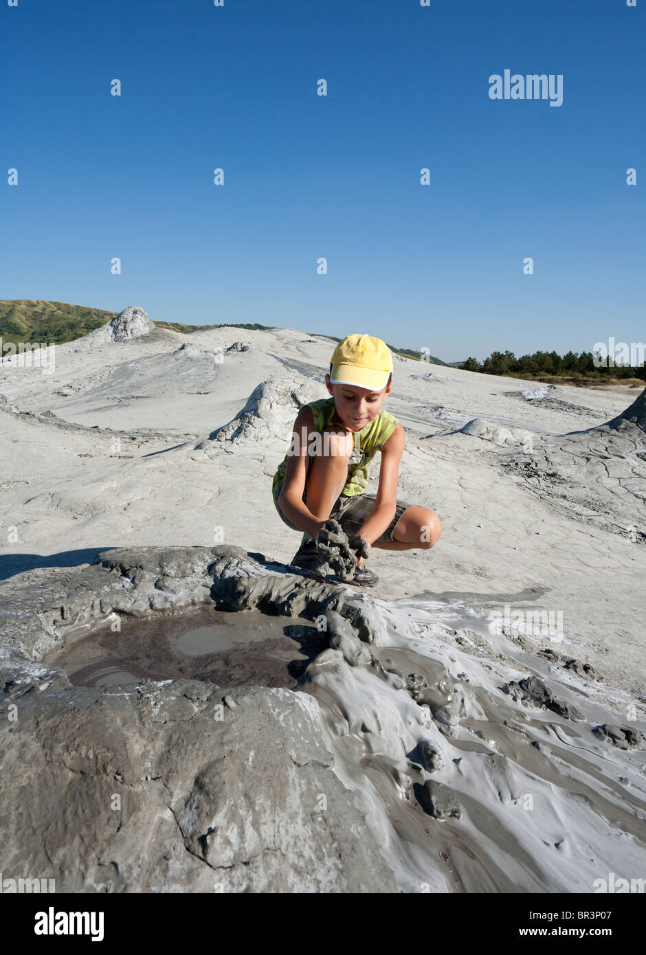 Cute kid playing with mud from muddy volcanoes at Berca, Romania Stock ...