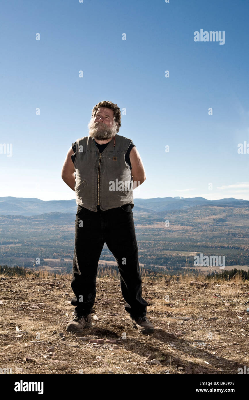 Grizzled man stands proud at top of a plateau Stock Photo - Alamy