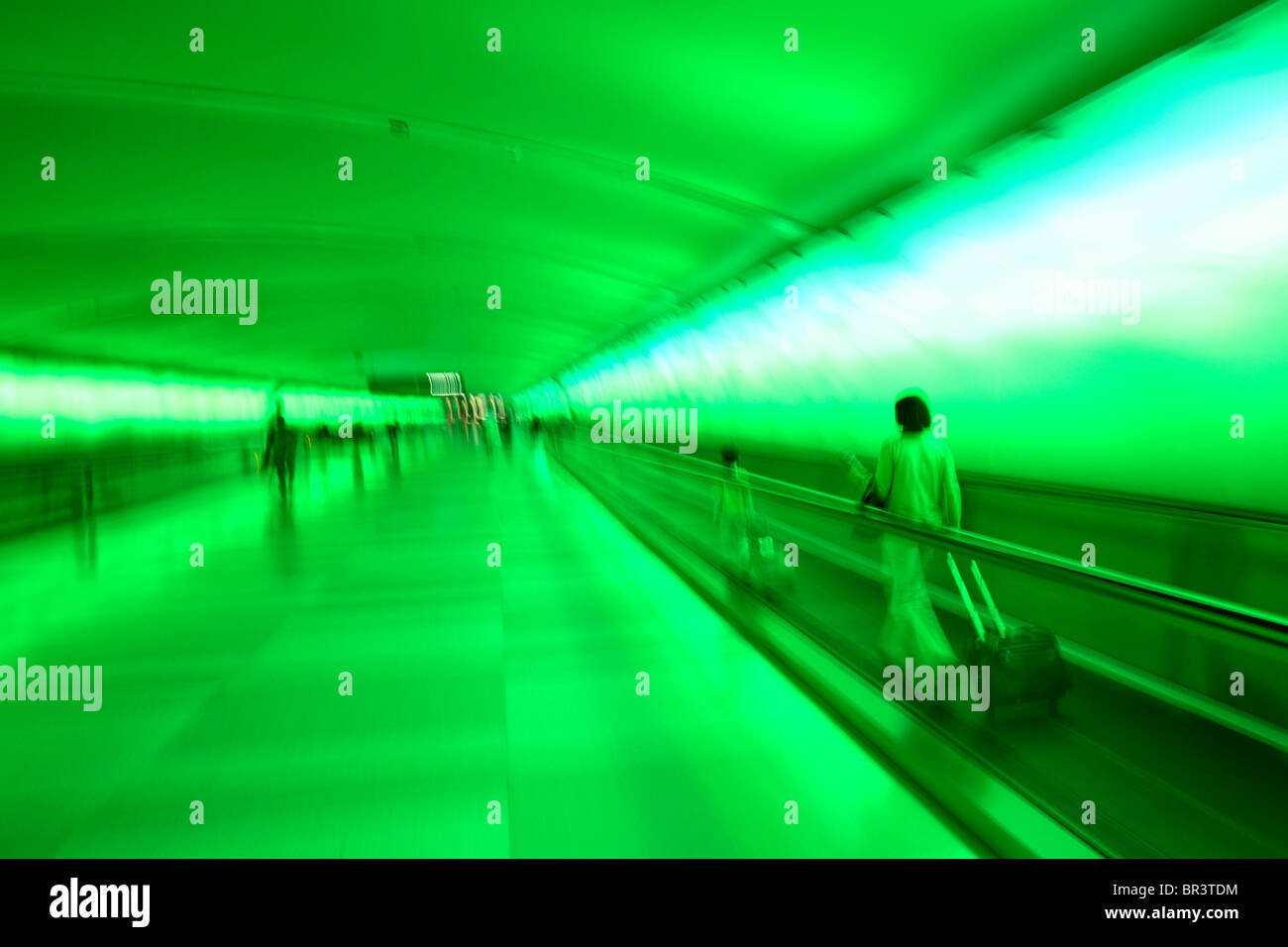 Passengers are whisked thru the surreally lit underground tunnel betwen ...