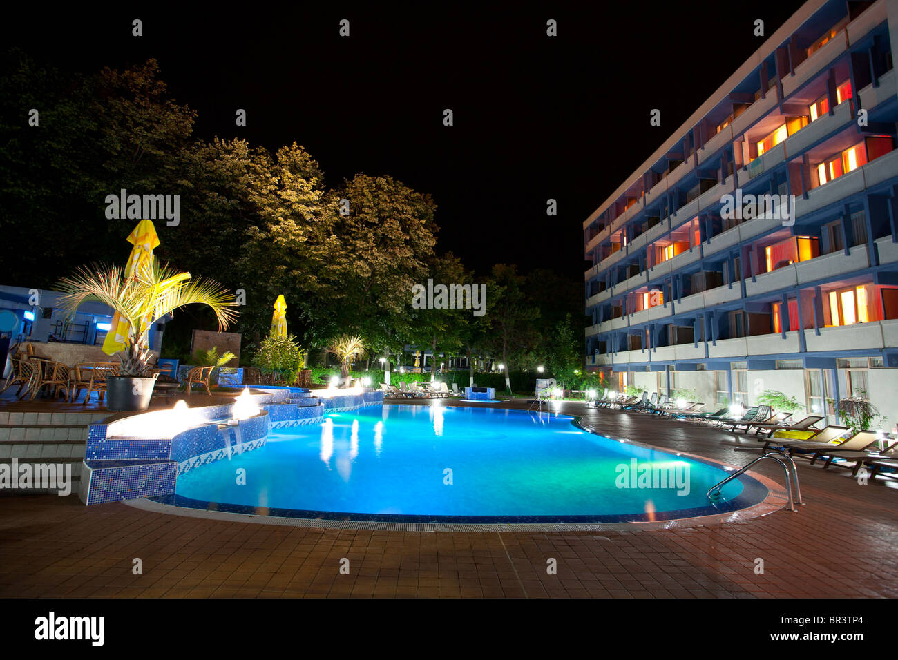 Hotel pool illuminated by artificial lighting at night Stock Photo - Alamy