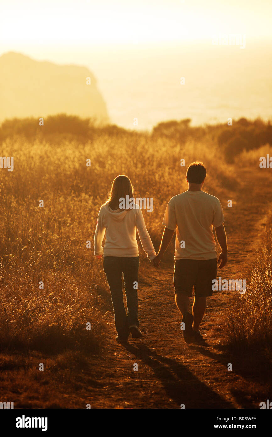 Holding hands in sunset, Big Sur, California Stock Photo - Alamy