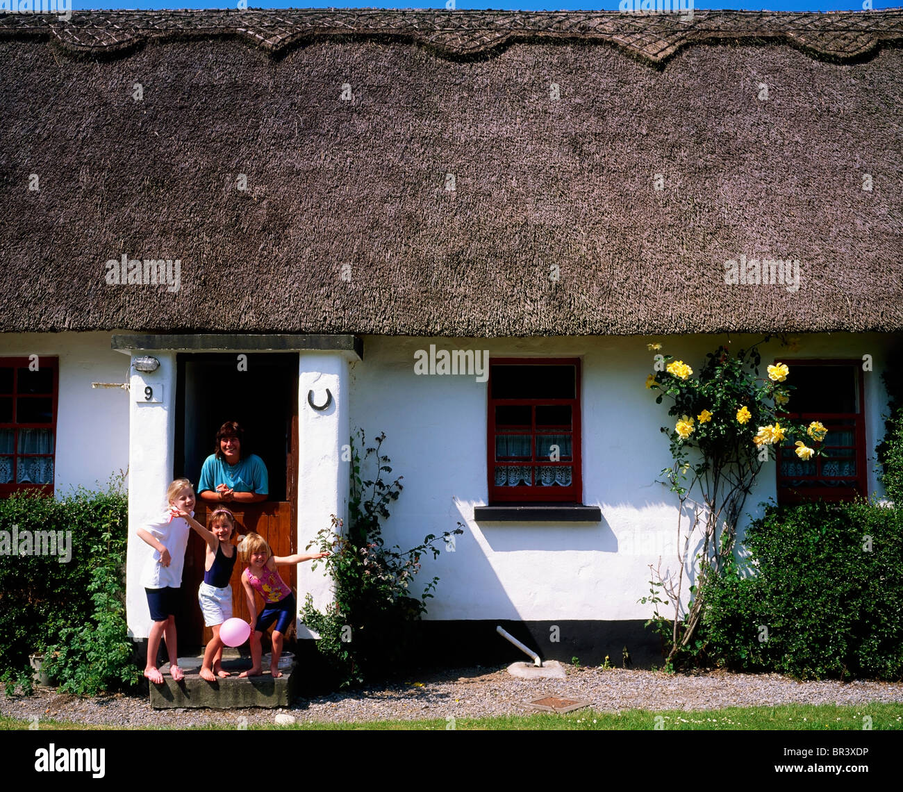 Puckane (Puckaun), Co Tipperary, Ireland, Family Outside Cottage Stock ...