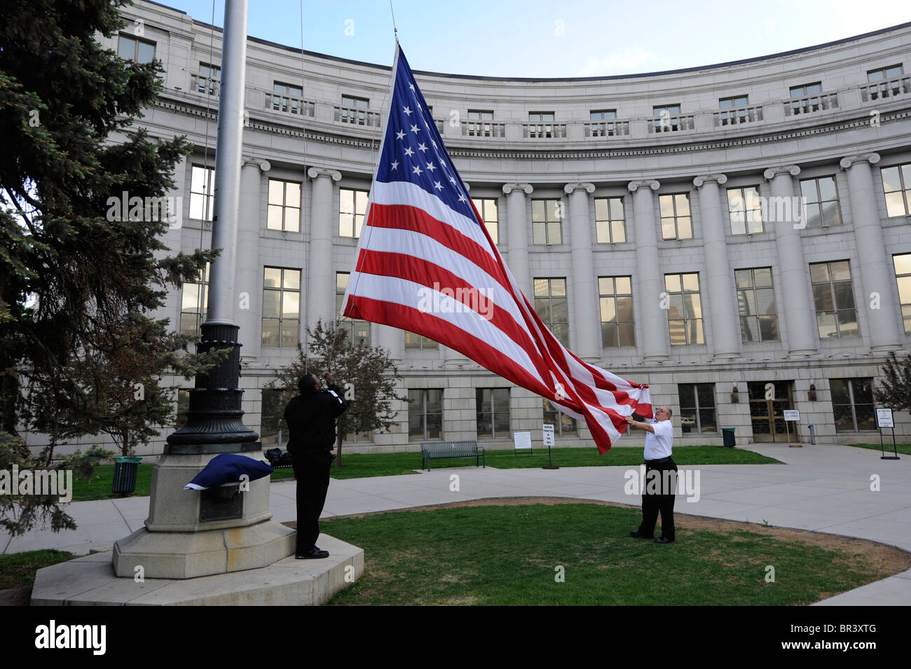 American Flag being lowered at sunset Denver Colorado Stock Photo - Alamy