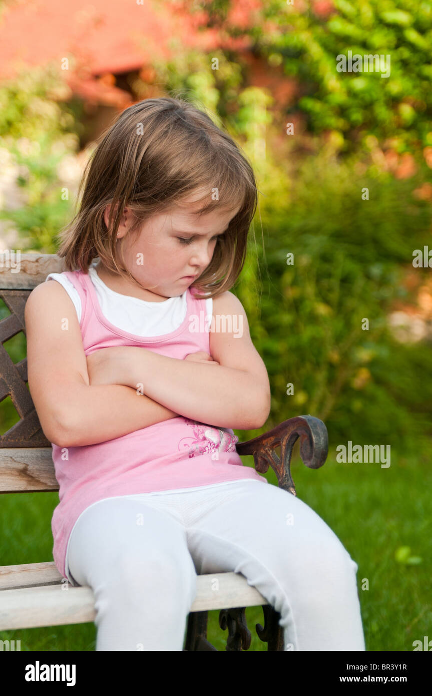 Outdoors portrait of small cute girl with offended look Stock Photo - Alamy