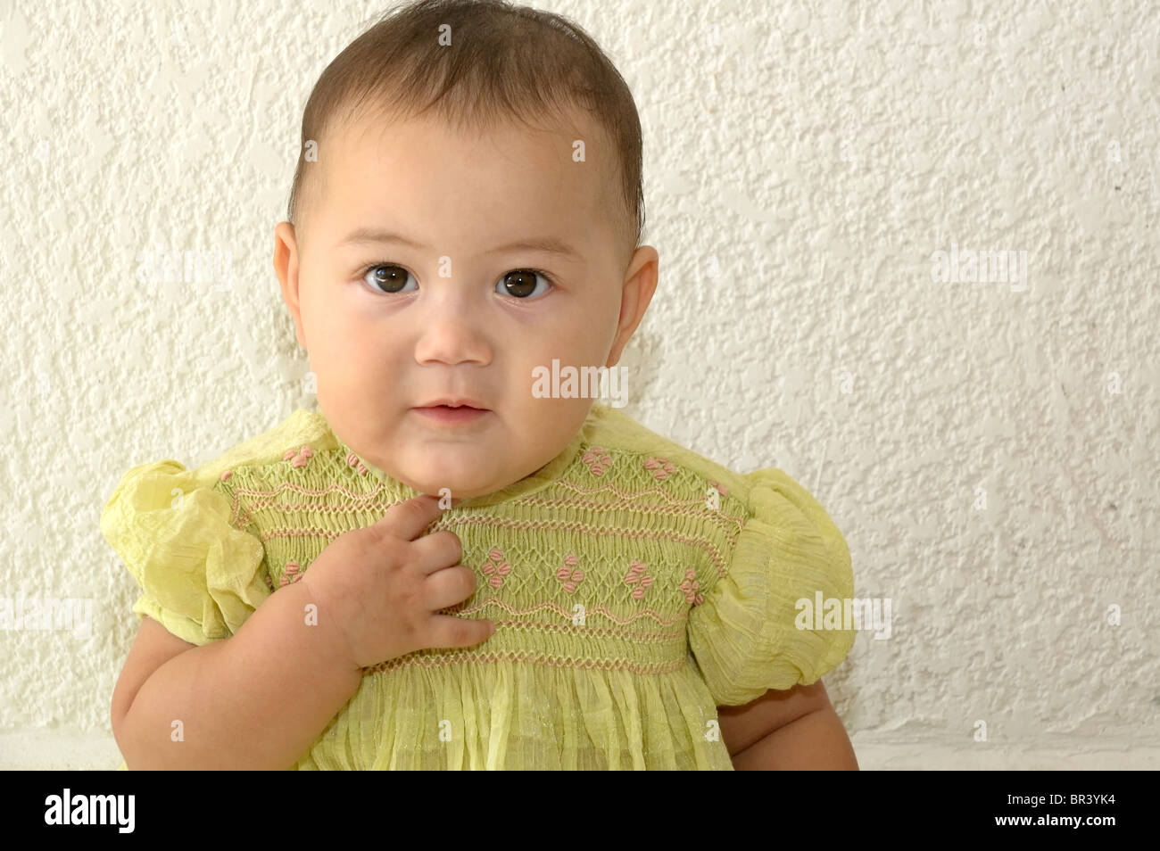 Tulum, Quintana Roo/Mexico - May 4: Baby girl in green dress looking to ...