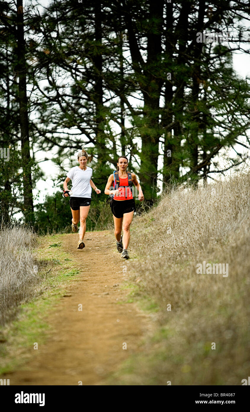 Two women trail running together Stock Photo - Alamy