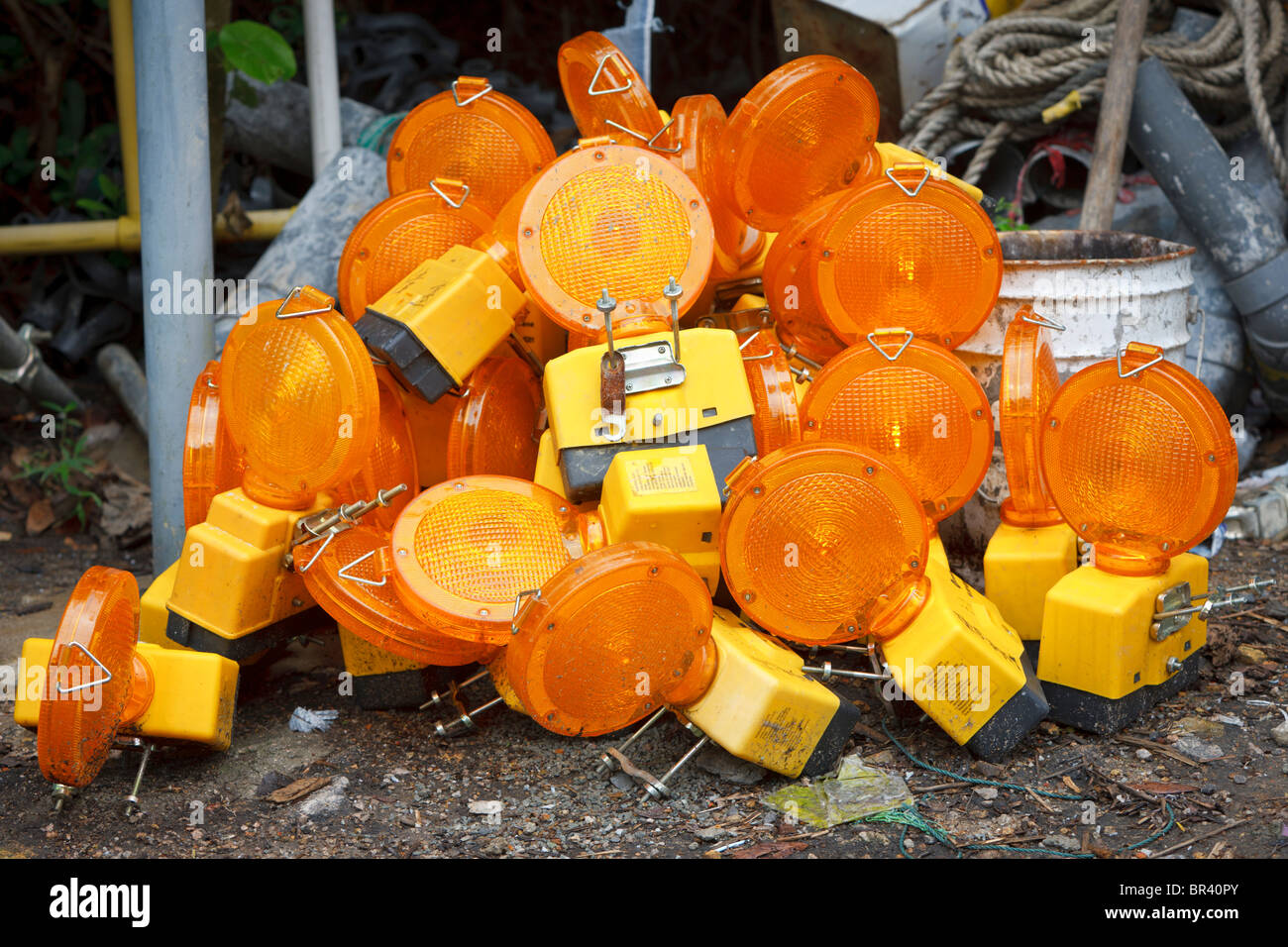 A heap of orange lensed battery operated road construction warning ...