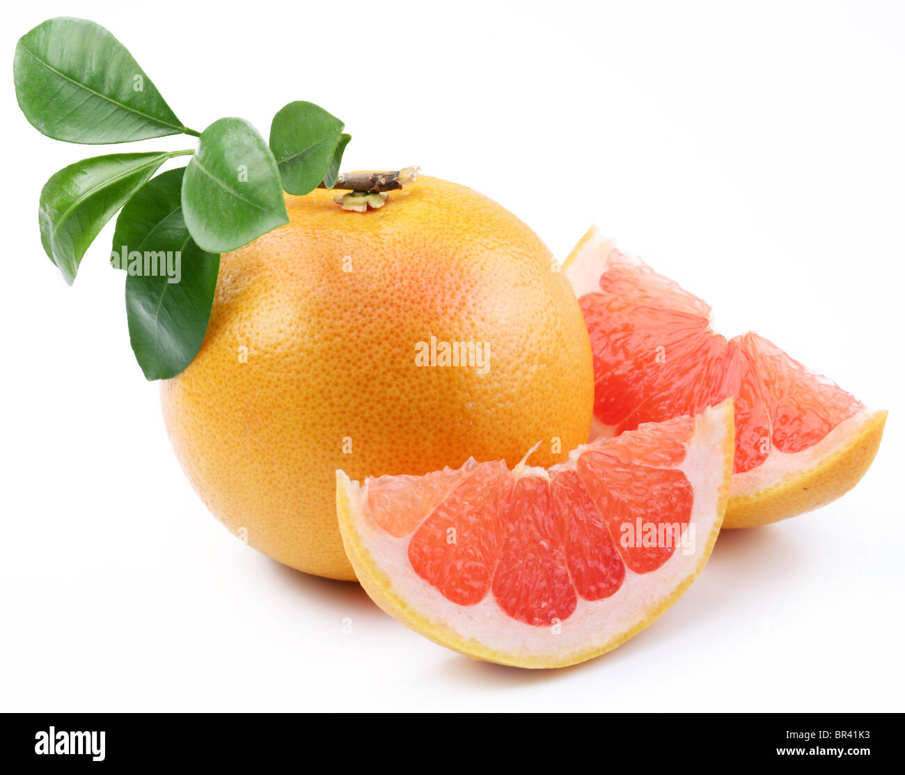 Ripe grapefruit with leaves and slices on white background Stock Photo ...