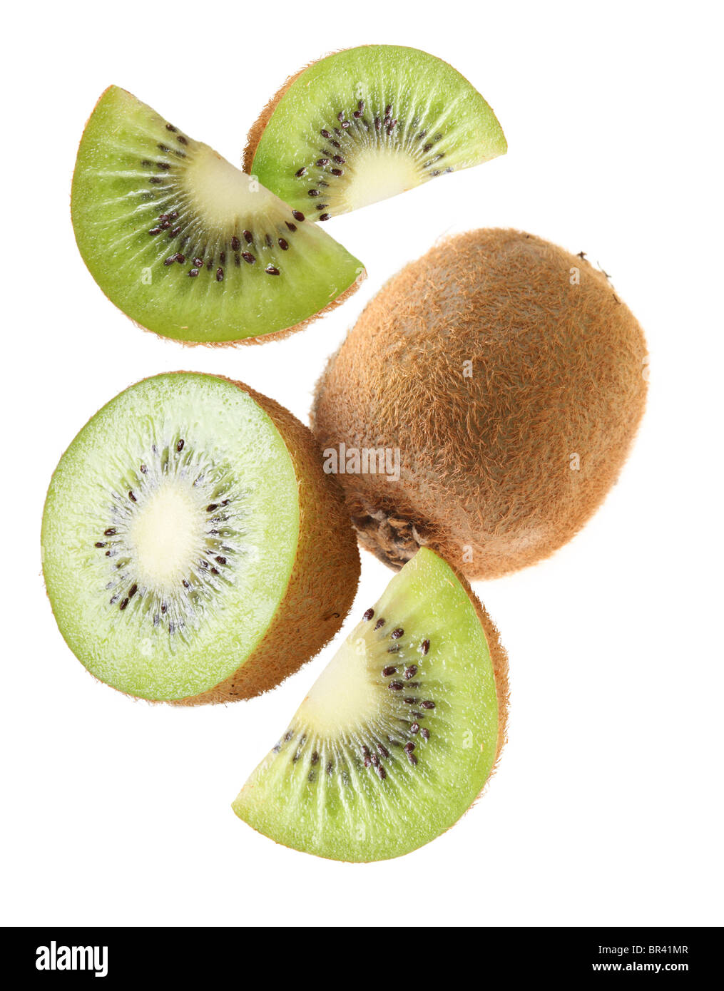 Falling kiwi fruit and kiwi slices. Isolated on a white background ...