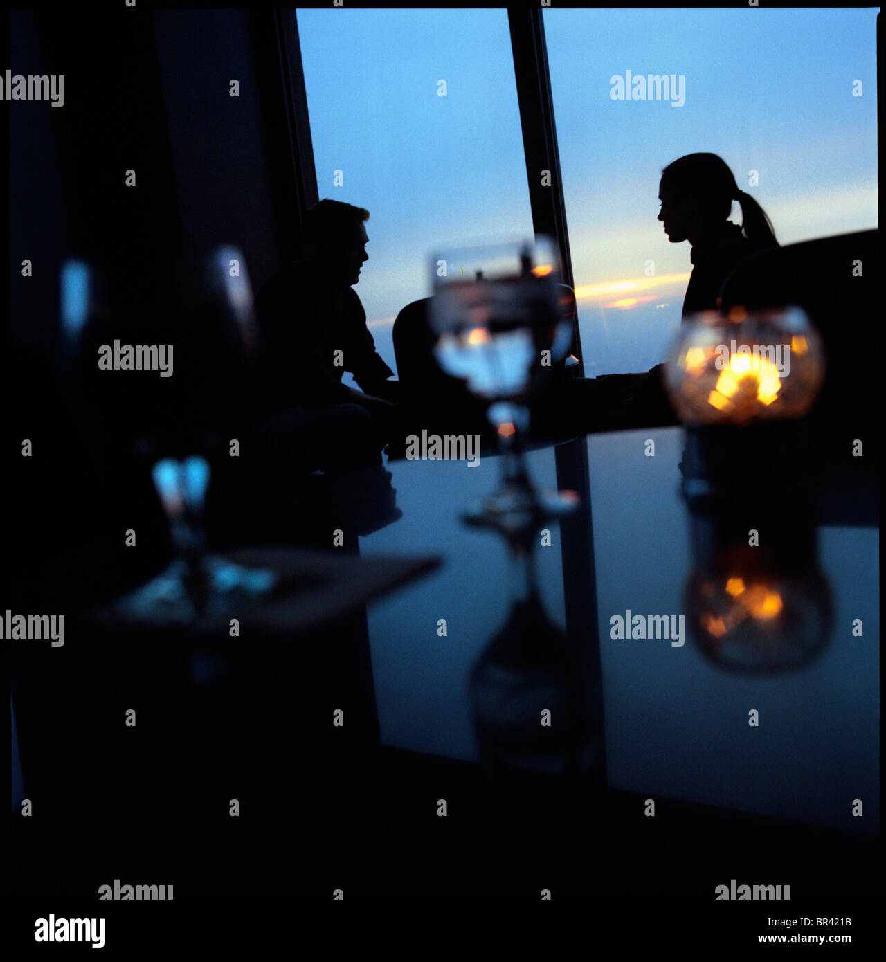 Silhouettes of a couple at an observation deck restaurant Stock Photo ...