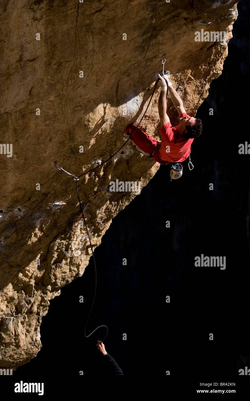 Man rock climbing on overhang route in Alquezar, Spain Stock Photo - Alamy