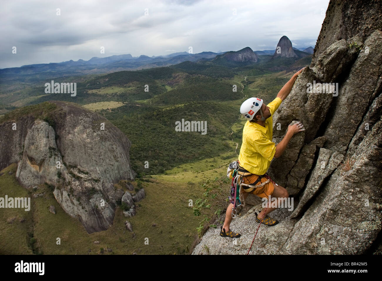Climber reaching a ledge in a big wall Stock Photo - Alamy