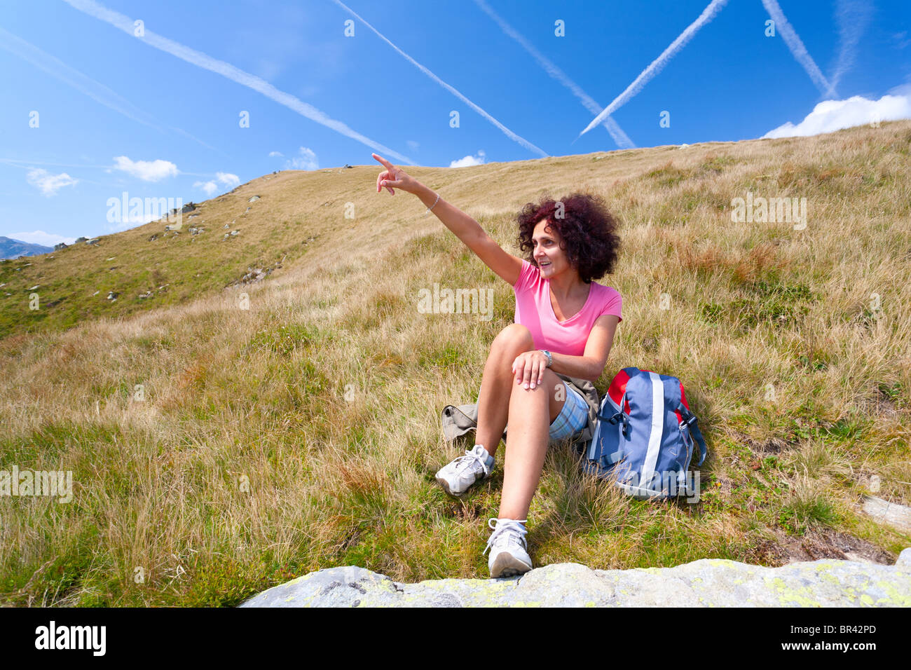 Attractive young woman hiking into a beautiful alpine landscape Stock ...